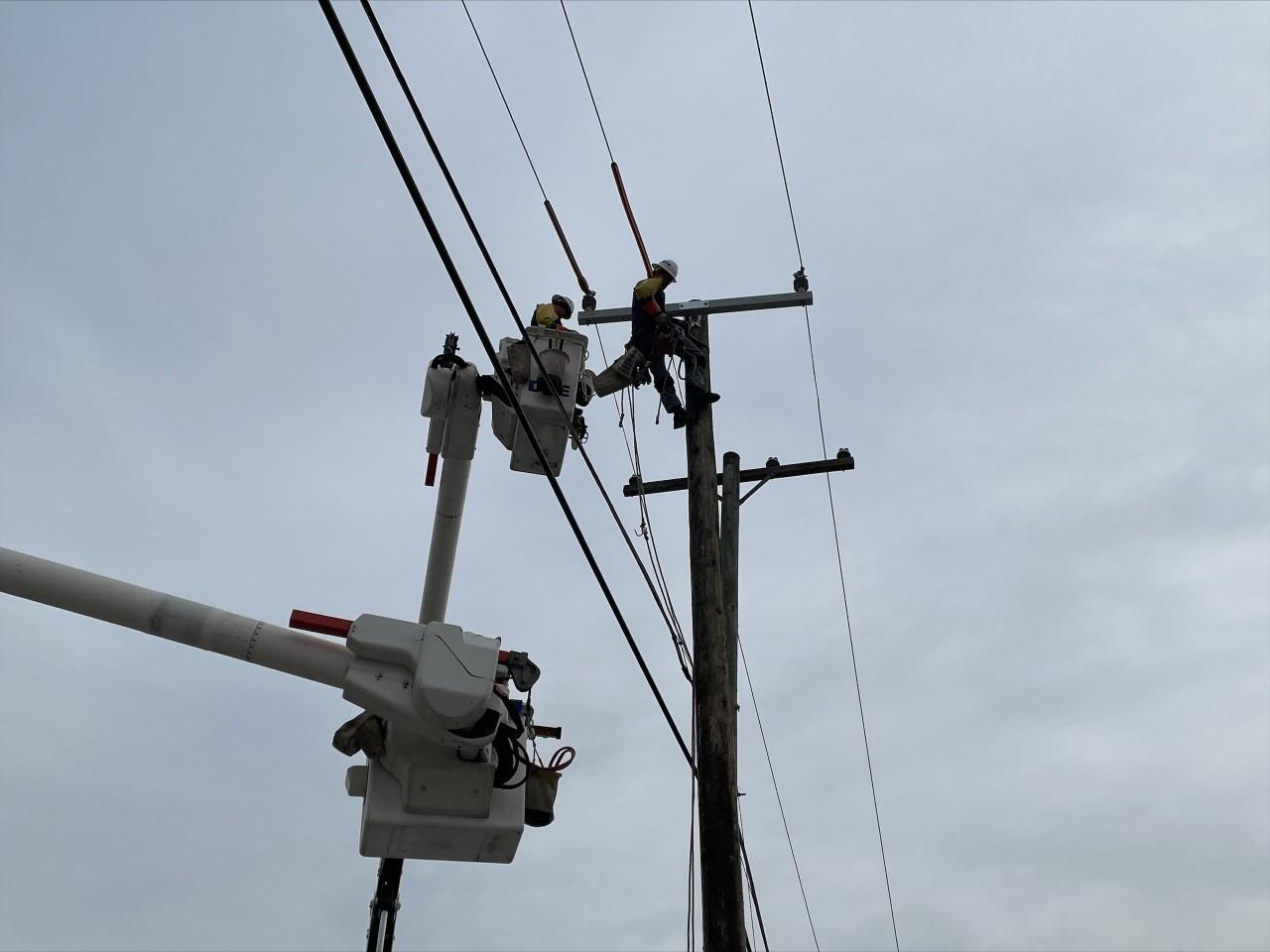 Overhead crews install equipment for reliable power - Empowering Michigan